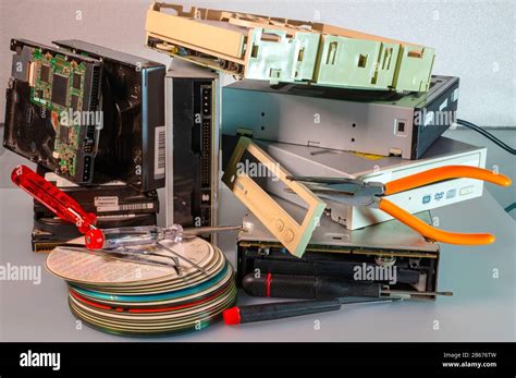 Stack Of Old Sata Ata Hard Disk Drives And Driver Cd Disassembled