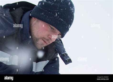 Portrait Of An Assembler Worker In A Jacket With A Hood At The