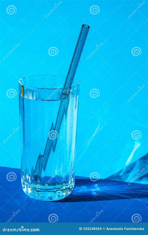 Reusable Glass Straws In Glass With Water On Blue Background Eco