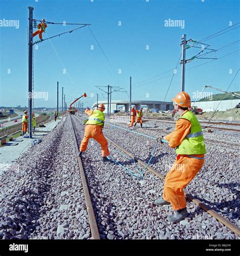 Power Engineers Installing Overhead Catenary System To Provide Traction
