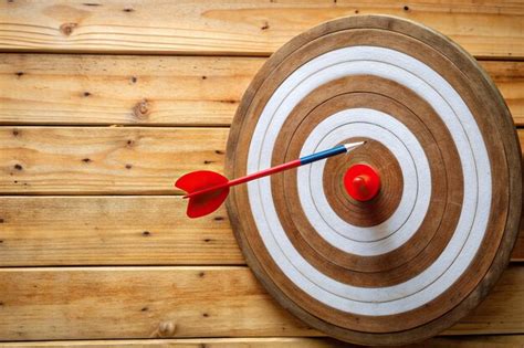 A Birds Eye View Of A Target Board With A Red Arrow Off Center