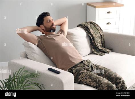 Soldier Napping On Soft Sofa In Living Room Military Service Stock