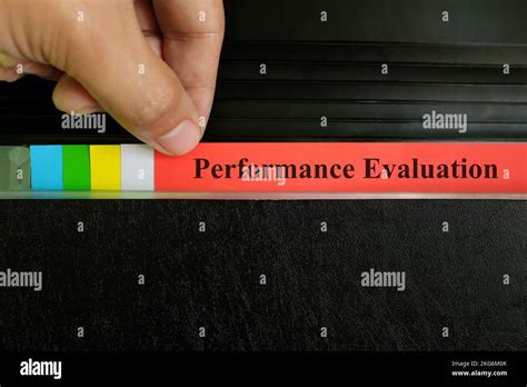employees performance evaluation file in black binder folder human