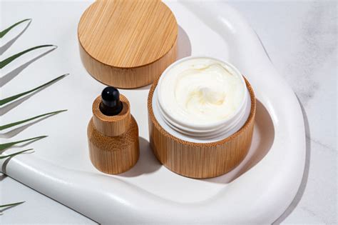 대나무 크림 항아리와 스포이드 병 와 대리석 배경에 쟁반에 와 화장품 용기 모형 브랜딩 및 포장 프레젠테이션을 위한 배경 천연