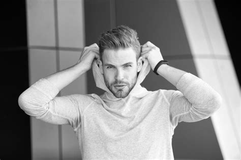 Premium Photo Guy Bearded And Attractive Puts On Hood Man With