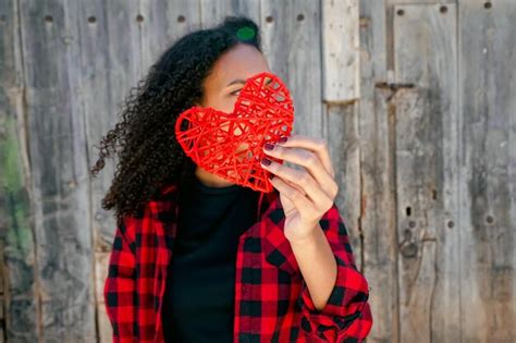 Premium Photo Woman Holding Heart Shape In Front Of Face