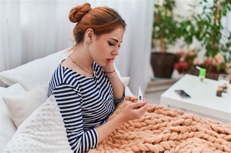 Premium Photo Girl With Thermometer In Her Hand Excitedly Checks Her Body Temperature