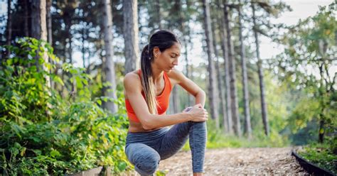 젊은 날씬한 스포츠맨은 자연의 보도에 웅크리고 다친 무릎을 잡고 있습니다 사진 Unsplash의 무릎 부상 이미지