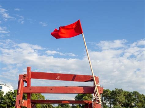 Premium Photo Red Flag On A Wooden Platform Flag As A Symbol Of