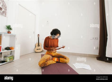 African American Attractive Young Woman Sitting In Yoga Pose With Legs