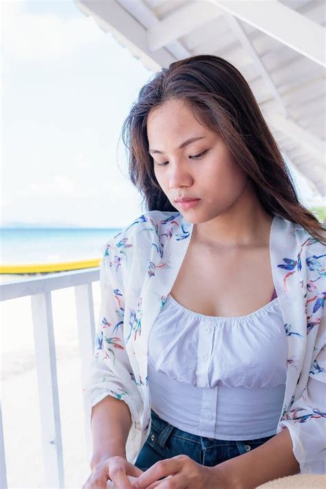 Worried Woman Sitting In The Restaurant Near The Seaside With A