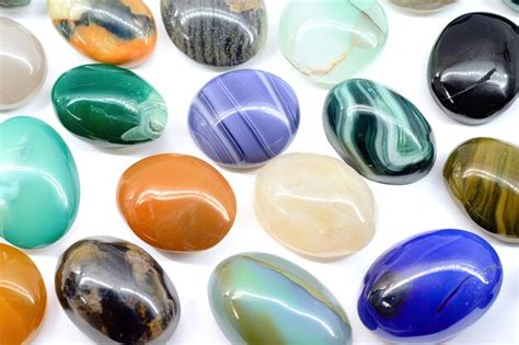 Natural Cabochon Stones In Various Colors And Patterns Displayed On A