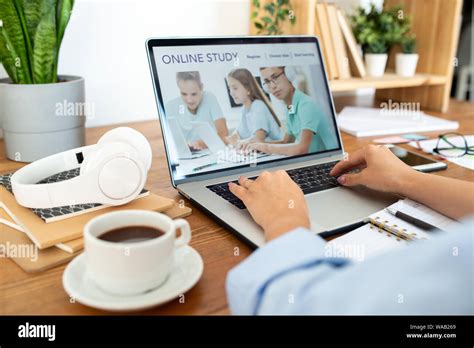 Female Hands Pressing Keys Of Laptop Keypad While Sitting In Front Of
