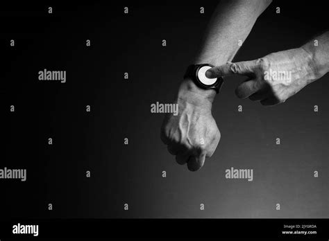 Black And White Image Of Man S Hand With Finger Pressing Smart Watch On Wrist Displaying Blank