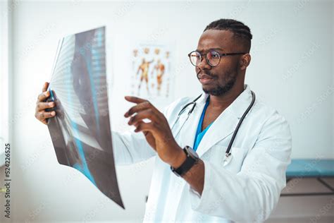 Male Radiologist Analyzing Chest X Ray Of An Patient At Medical Clinic