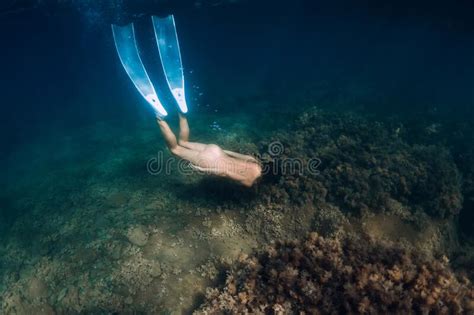 Naked Sporty Woman With Freediving Fins Dive In Ocean Stock Photo