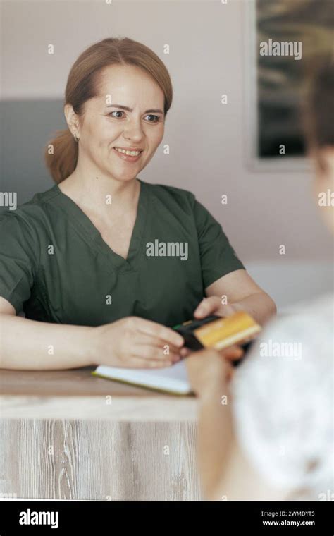 Healthcare Time Smiling Female Massage Therapist In Massage Cabinet With Client Accepting