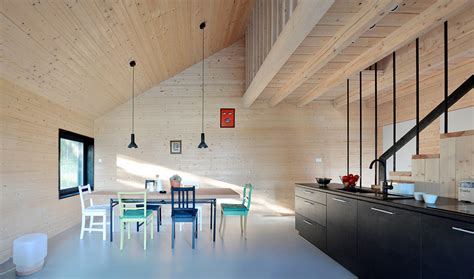 Asymmetric House Clad In Blackened Pine Stands In A Polish Forest