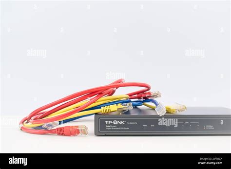 TP LINK Gigabit Broadband Network Router With Network Cables On A White Desk Stock Photo Alamy