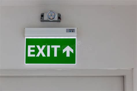 Green Emergency Exit Sign Showing The Way To Escapefire Exit In The