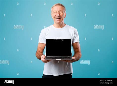 Happy Mature Man Showing Black Empty Pc Screen Stock Photo Alamy