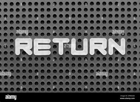 White Alphabet Letter In Word Return On Black Pegboard Background Stock