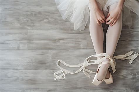 Ballerinas Graceful Pose On Wooden Floor Premium Ai Generated Image