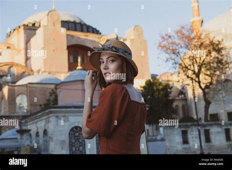 Beautiful Girl With Orange Colored Dress Posing With Hagia Sophia