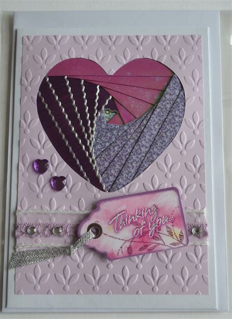A Pink Card With Hearts And Tags On It