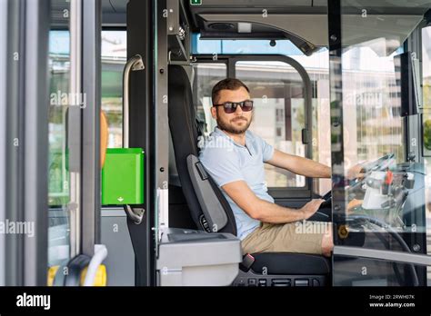 Portrait Of City Shuttle Bus Driver Man Wearing Sunglasses Sitting In