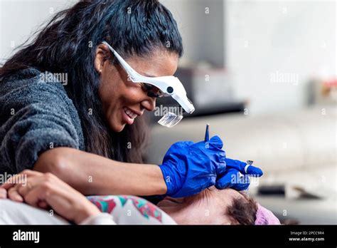 Side View Of Cheerful African American Female Microblading Master In