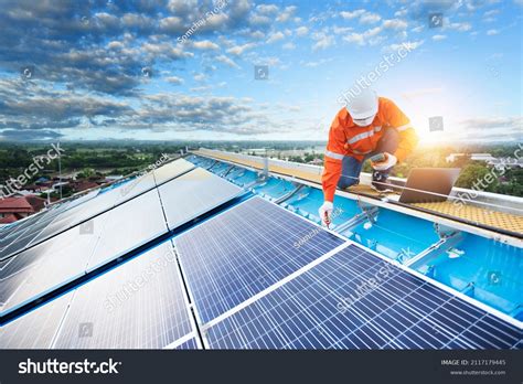 Technician Inspecting Solar Panel Maintenance On Stock Photo 2117179445
