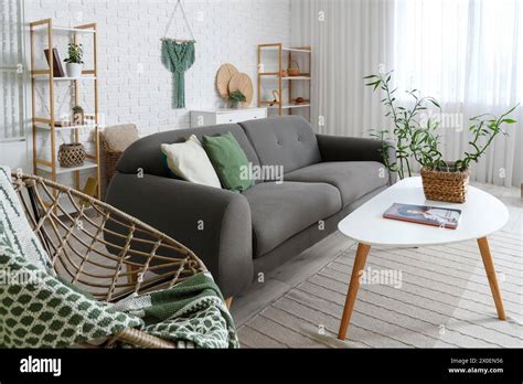 Light Interior Of Modern Living Room With Bamboo Stems On Coffee Table
