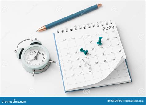 calendar scheduling and planning with blue pin and clock stock image
