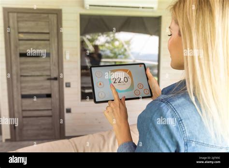 Modern Home Smart Automation App On Tablet Display In Woman Hands Stock