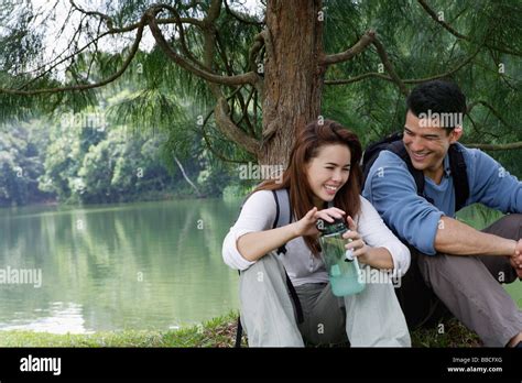 Couple Resting Under Tree Stock Photo Alamy