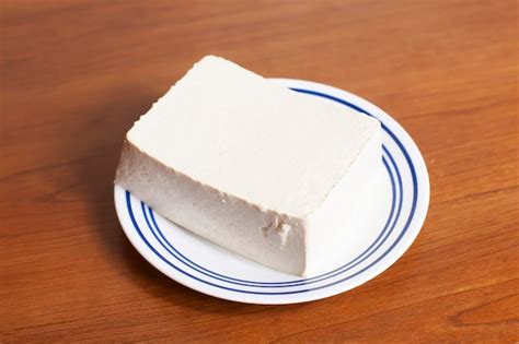 Block Of Raw Tofu On A Small Serving Plate Premium Photo