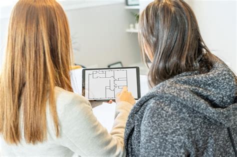 Premium Photo Female Real Estate Agent Showing Her Client The Plans