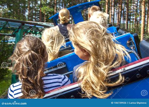 Rear View Shot Of Young People On A Thrilling Roller Coaster Ride At
