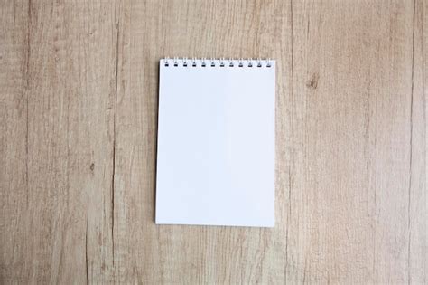 Premium Photo Checkered Notepad On A Wooden Table