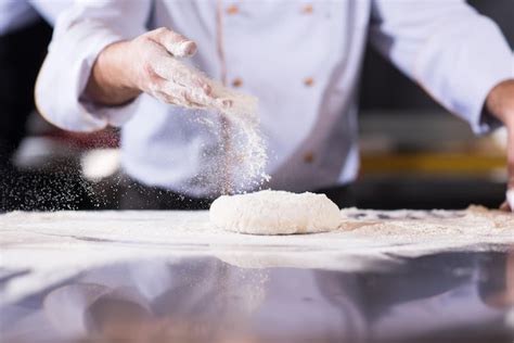 Premium Photo Chef Hands Preparing Dough For Pizza On Table Sprinkled