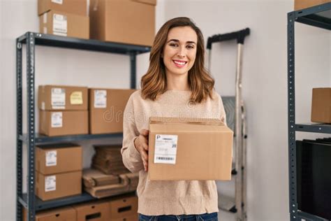 Young Woman Ecommerce Business Worker Holding Package At Office Stock