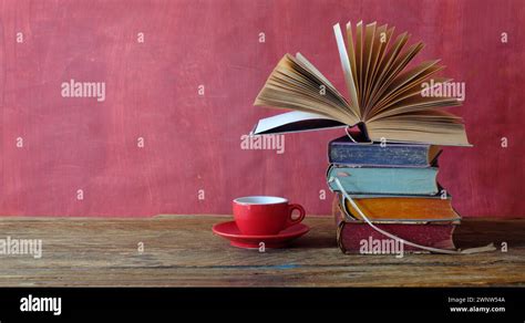 Stack Of Books With Open Book And Cup Of Espresso Coffee Reading