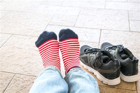 Premium Photo Womans Feet With Colorful Socks And Sport Shoes By The