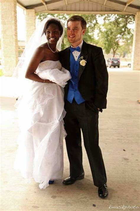 A Bride And Groom Posing For A Photo