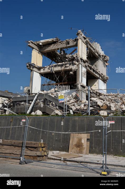 Safety Barrier In Front Of Partly Demolished Reinforced Concrete Multi