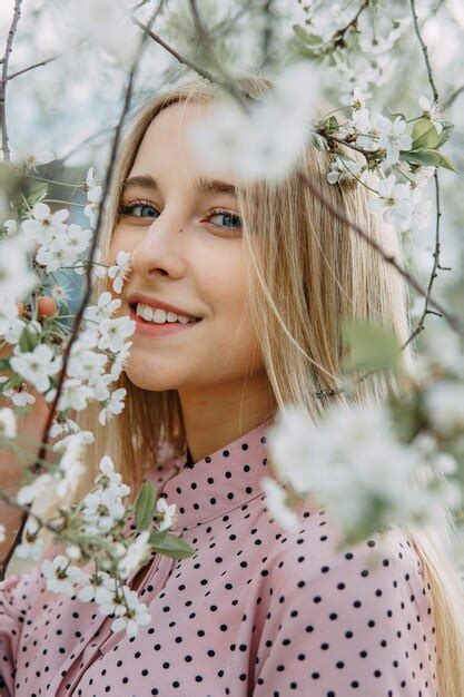 Premium Photo Blonde Girl On A Spring Walk In The Garden With Cherry