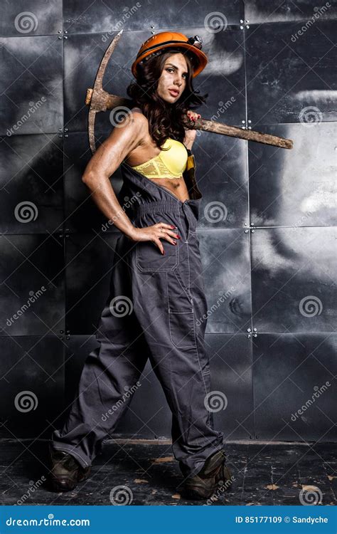 Female Miner Worker With Pickaxe In Coveralls Over His Naked Body Sitting On The Floor On