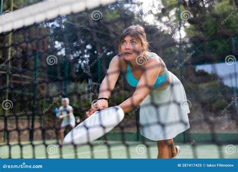 Female Player Playing Padel In A Padel Court Outdoor Behind Net Stock
