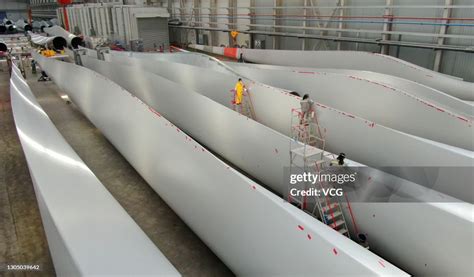 Employees Work On The Assembly Line Of Wind Turbine Blade At A News